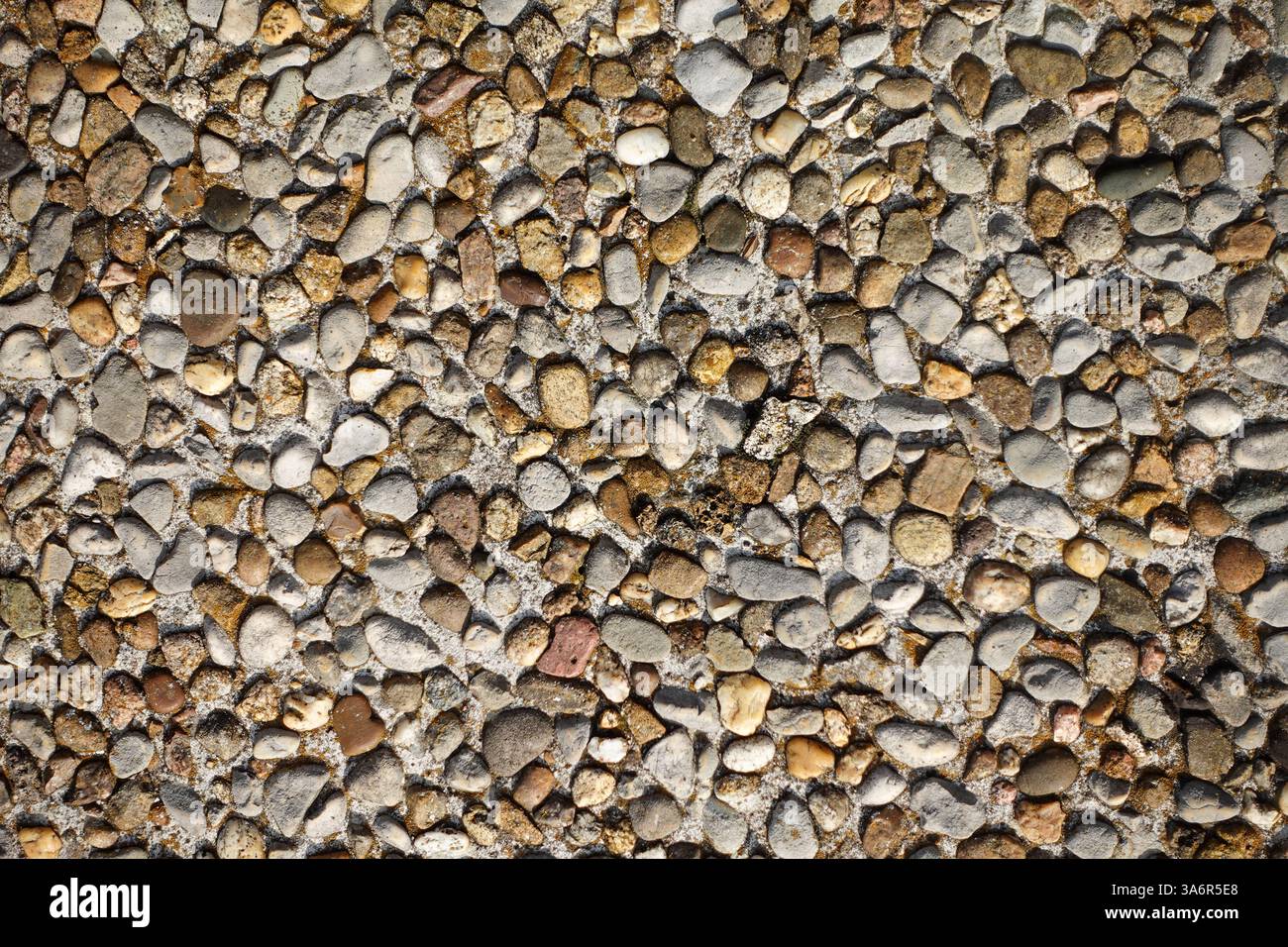 Textured Pebble Stone Pavement in Sunlight Stock Photo - Alamy