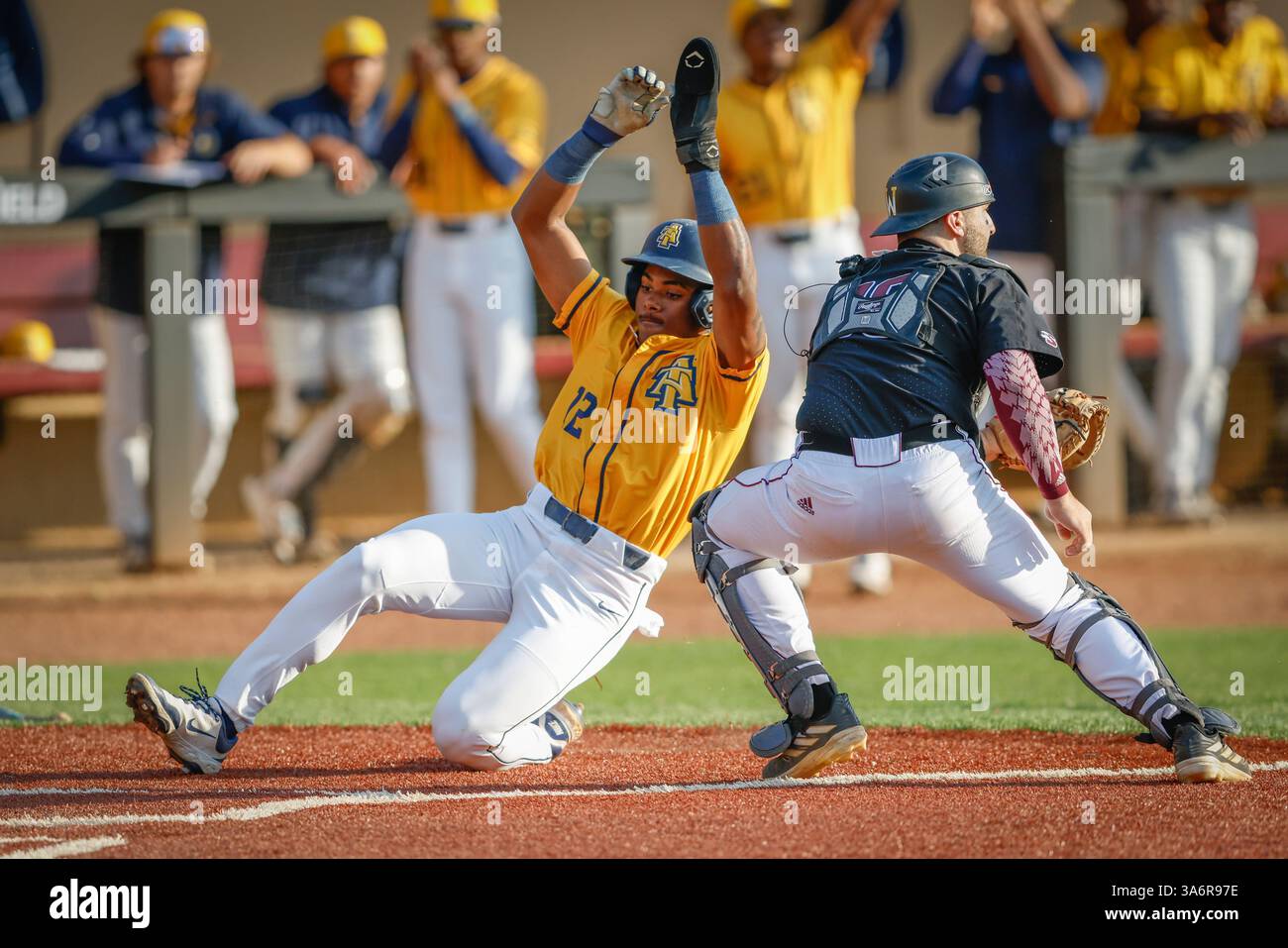 N.C. A&T baserunner Bruce Wyche slides safely into home against ...