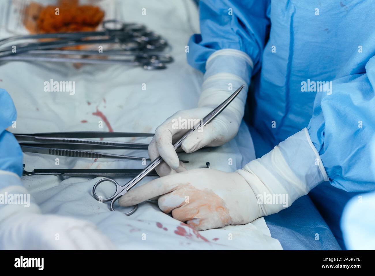 Nurse hand taking surgical instrument for group of surgeons at ...