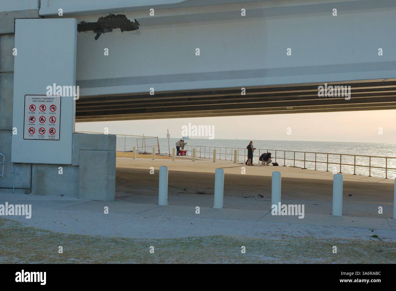 Group of people fishing with rods under a draw bridge at John's Pass ...