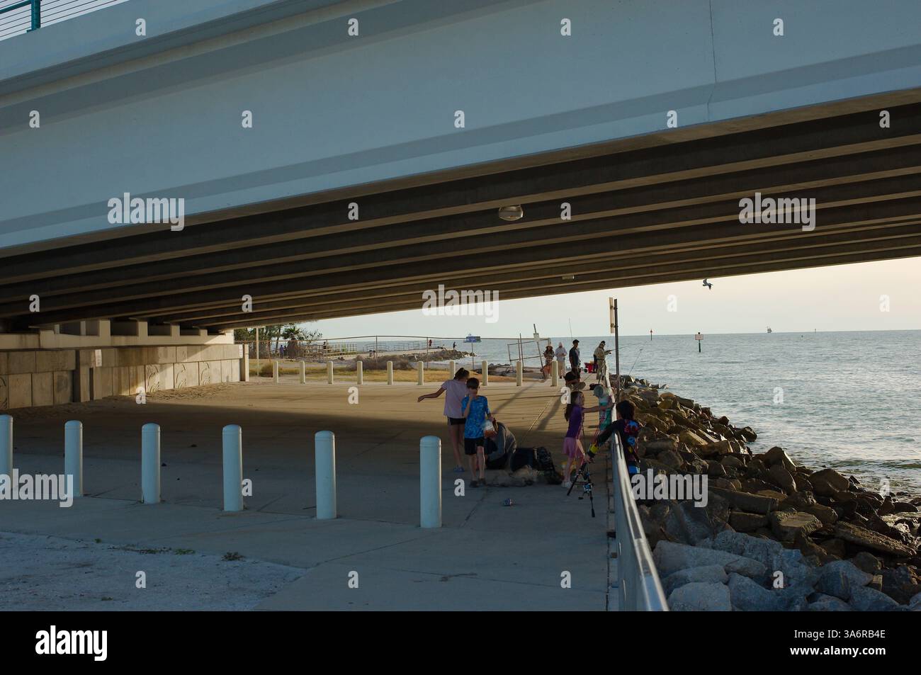 Group of people fishing with rods under a draw bridge at John's Pass ...