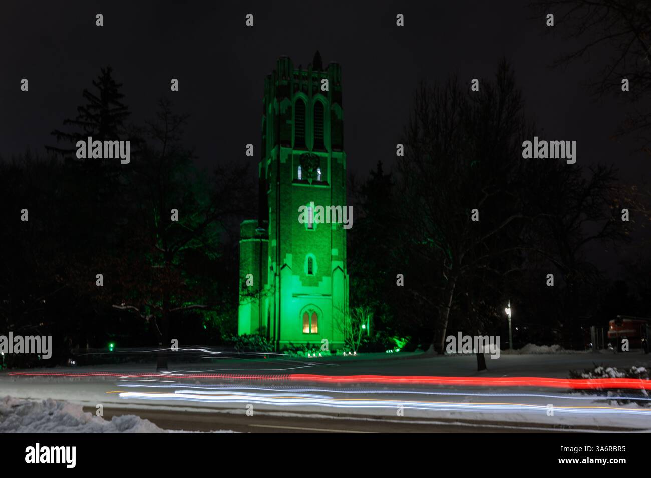 East Lansing, USA. 13th Feb, 2025. Beaumont Tower is illuminated in ...