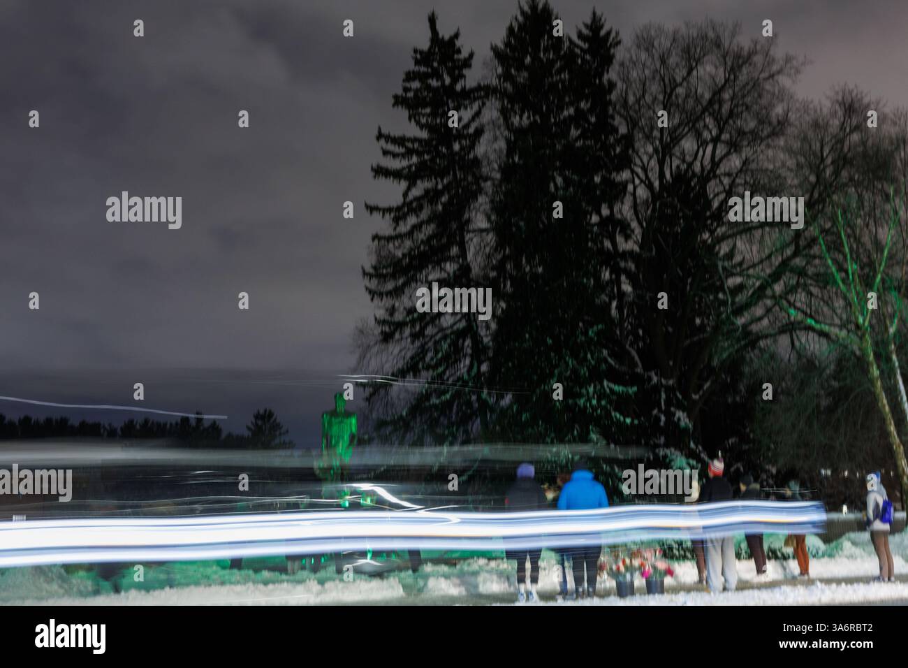 Community members leave flowers and luminaries at the Spartan Statue on ...