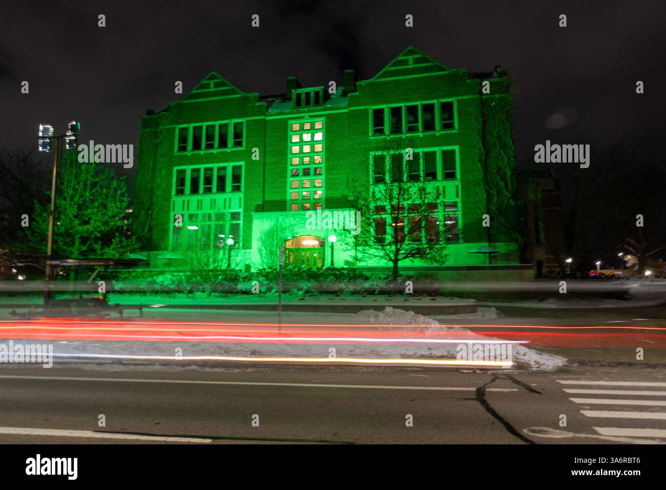 The MSU Union is illuminated in green as community members leave ...