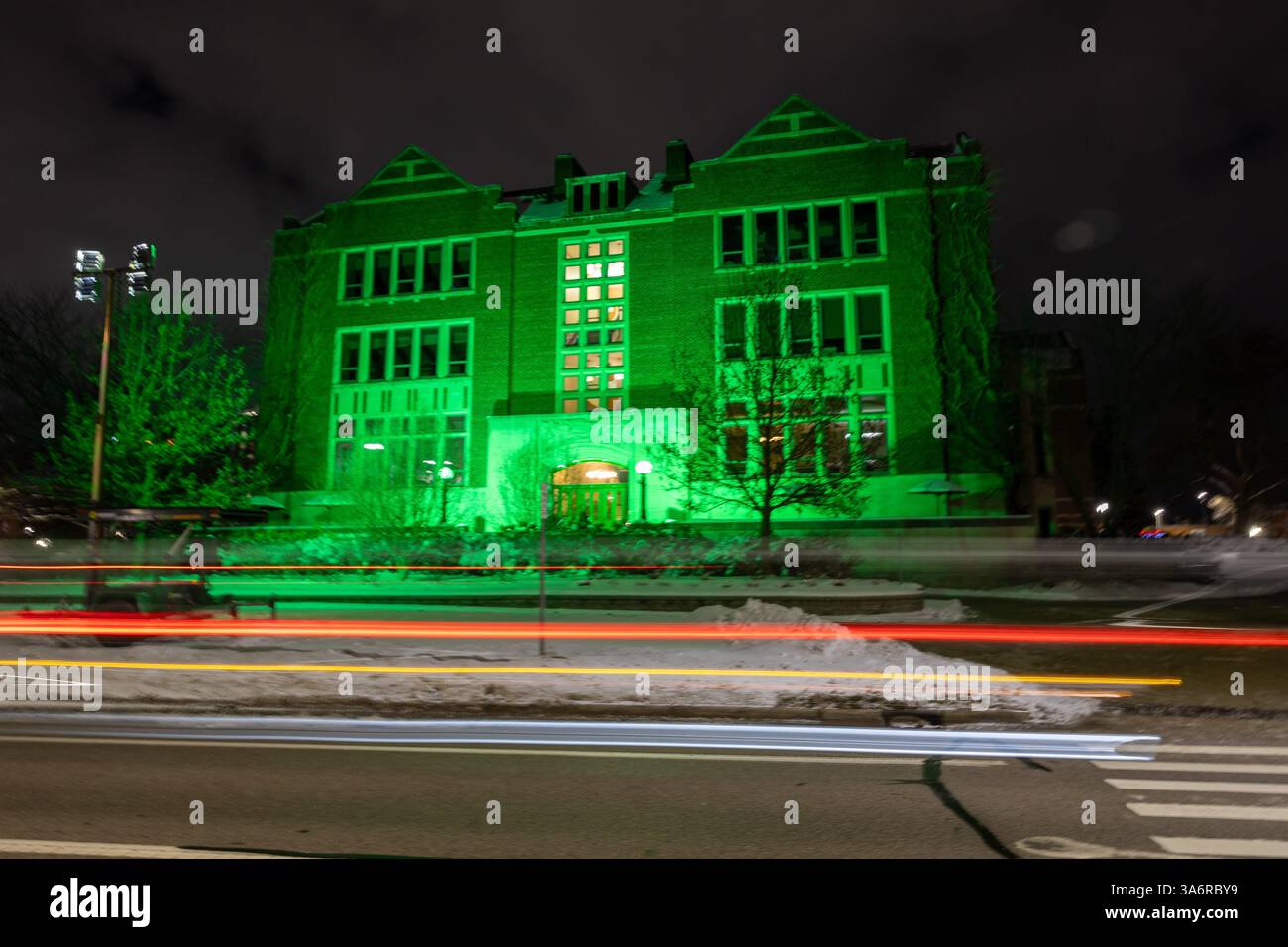 The MSU Union is illuminated in green as community members leave ...