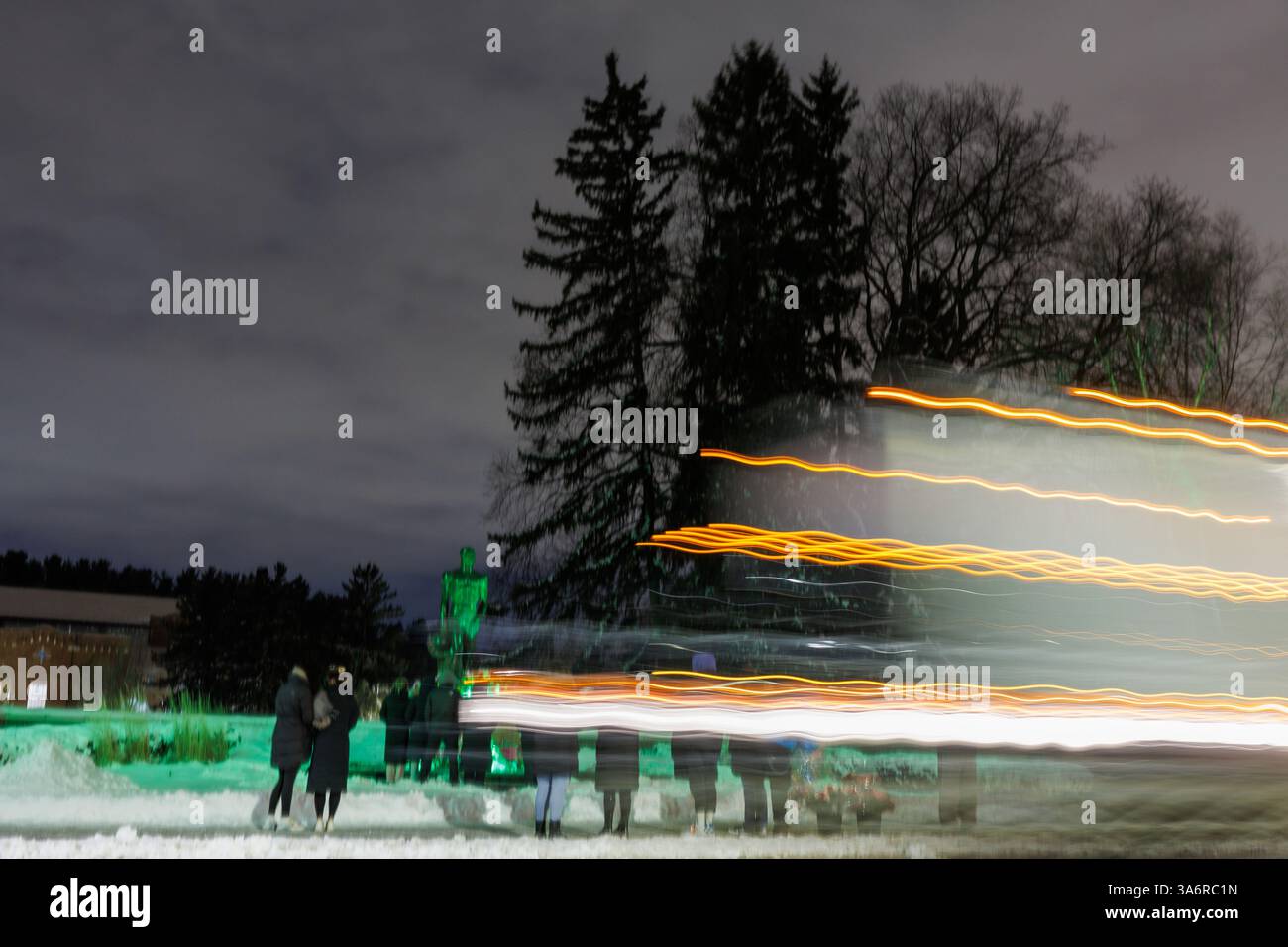 Community members leave flowers and luminaries at the Spartan Statue on ...