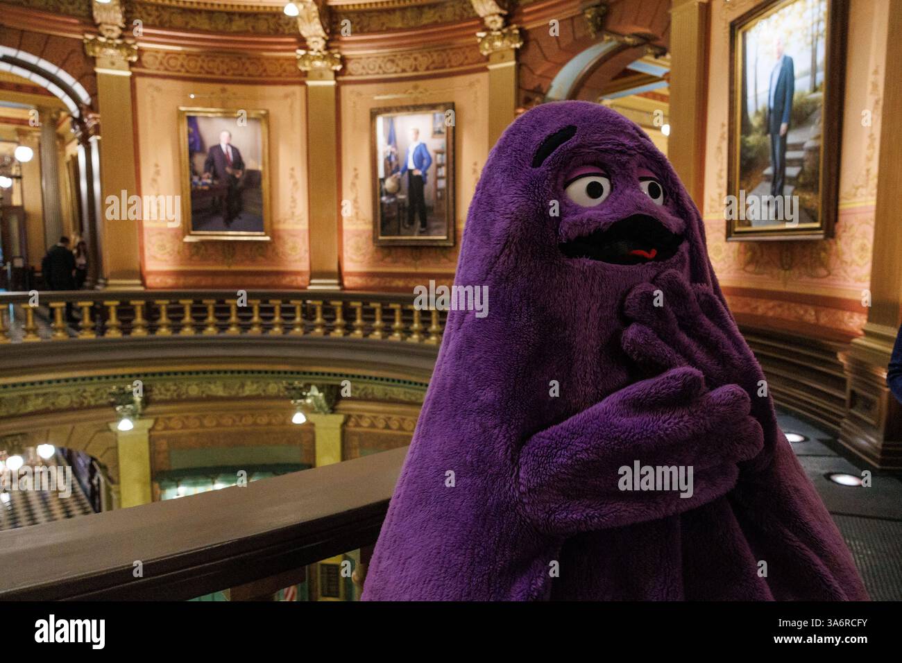 Lansing, USA. 18th Mar, 2025. McDonald's mascot Grimace visits the ...