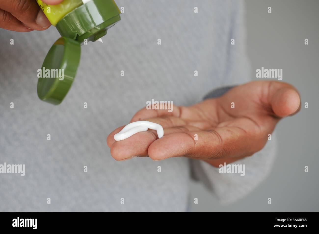 Hand applying soothing cream hi-res stock photography and images - Alamy
