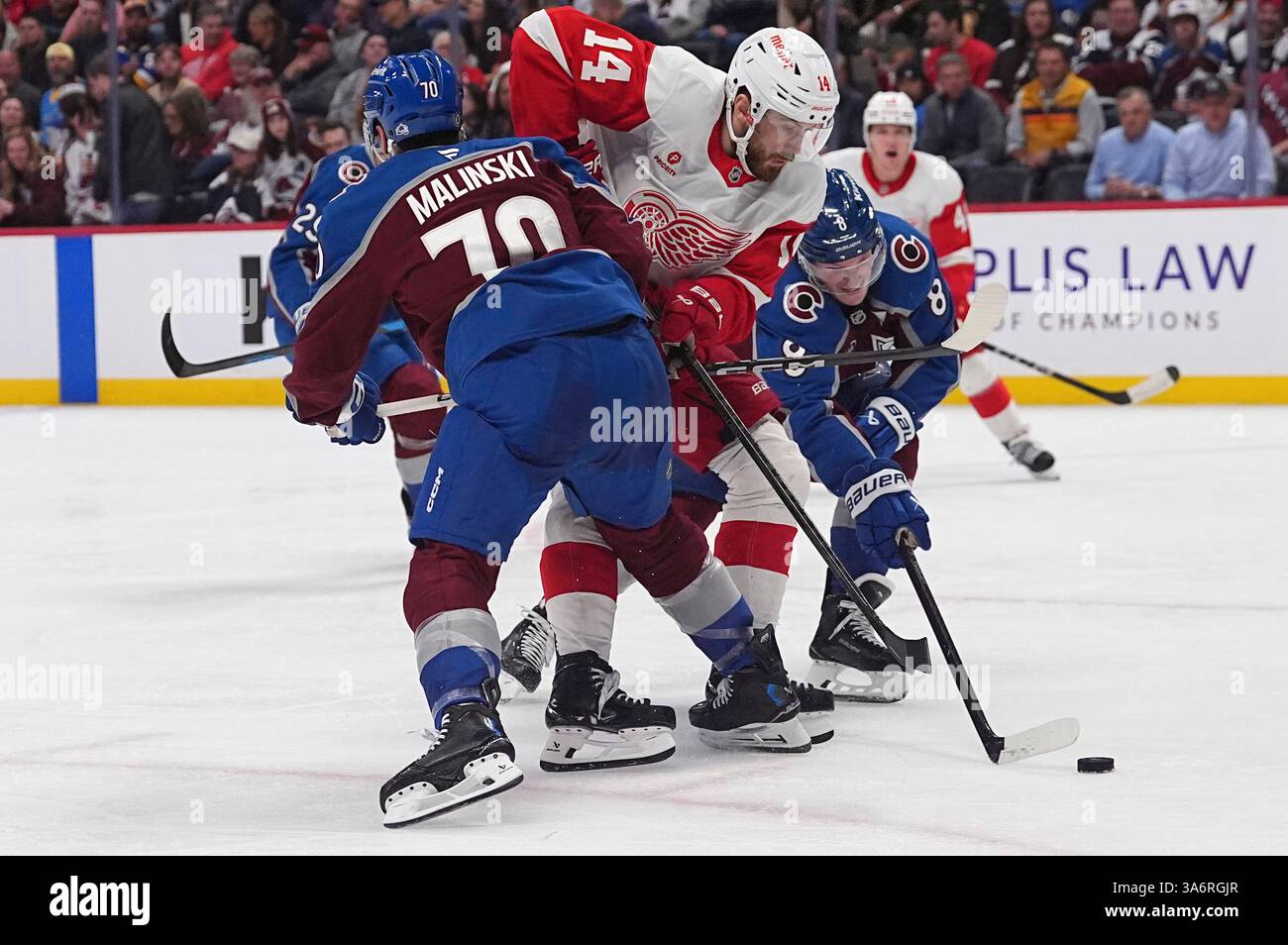 Detroit Red Wings center Tyler Motte, center, is caught between ...