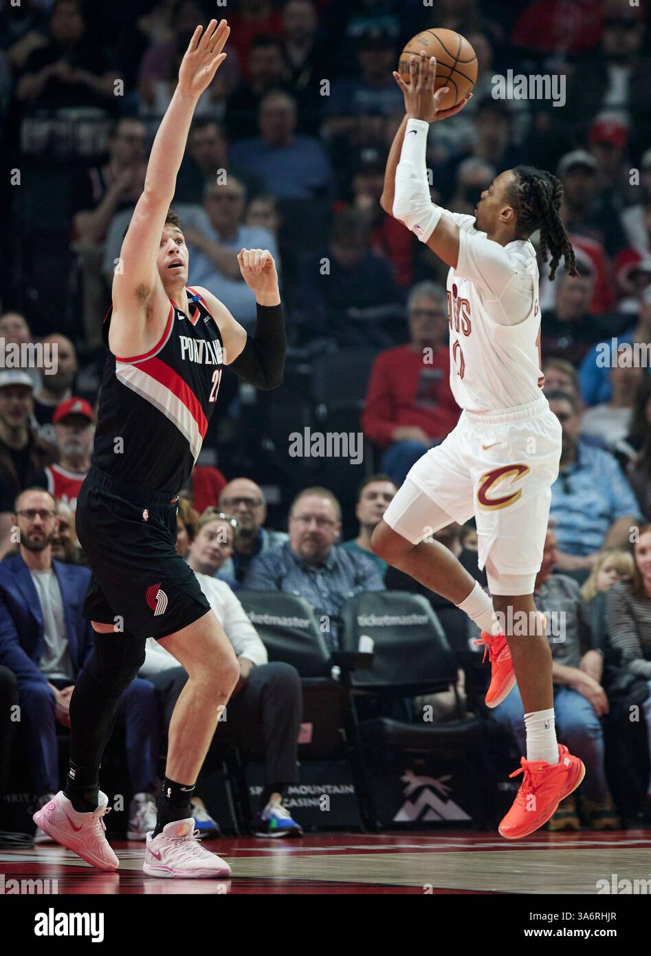 Cleveland Cavaliers guard Darius Garland, right, shoots over Portland ...