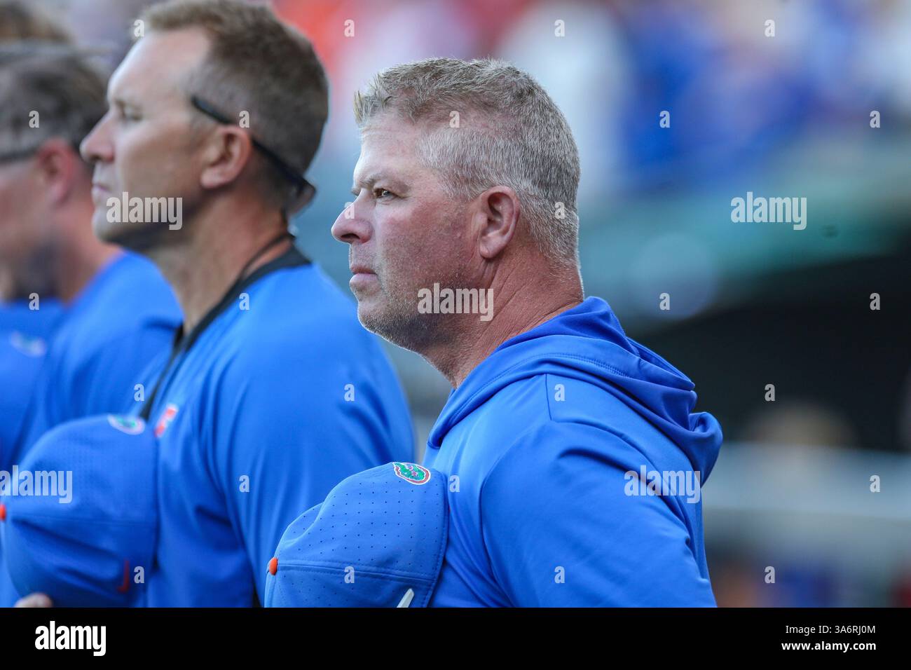 Florida head coach Kevin O'Sullivan lines up with his team on the field ...