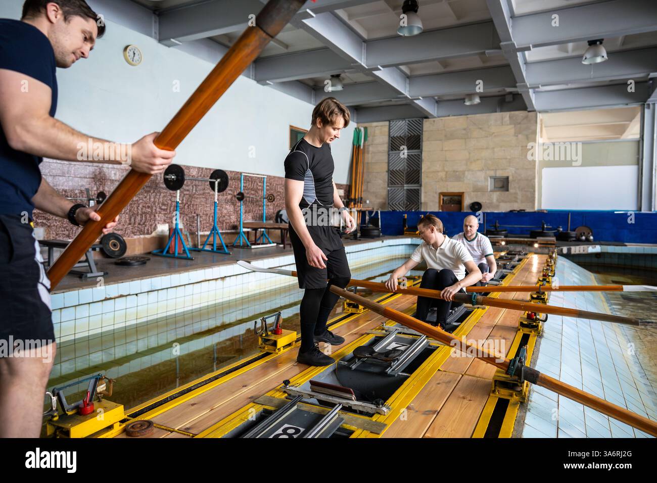 Focused strategic athletes organize seating for rowing simulation in ...
