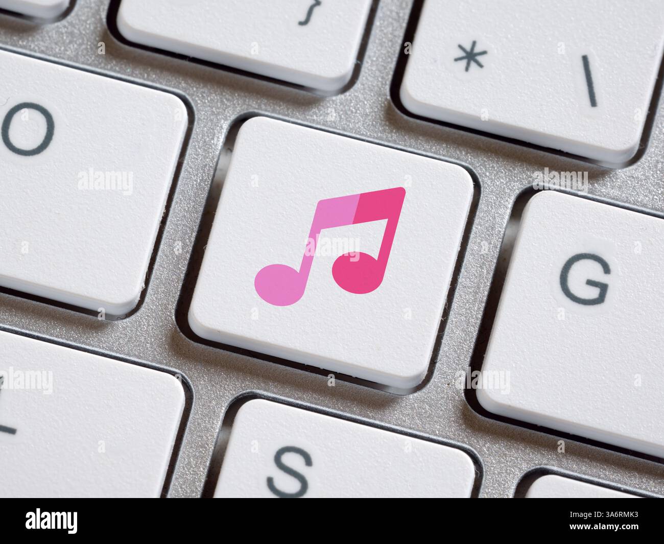 Listening to online music. Computer keyboard with musical note button ...