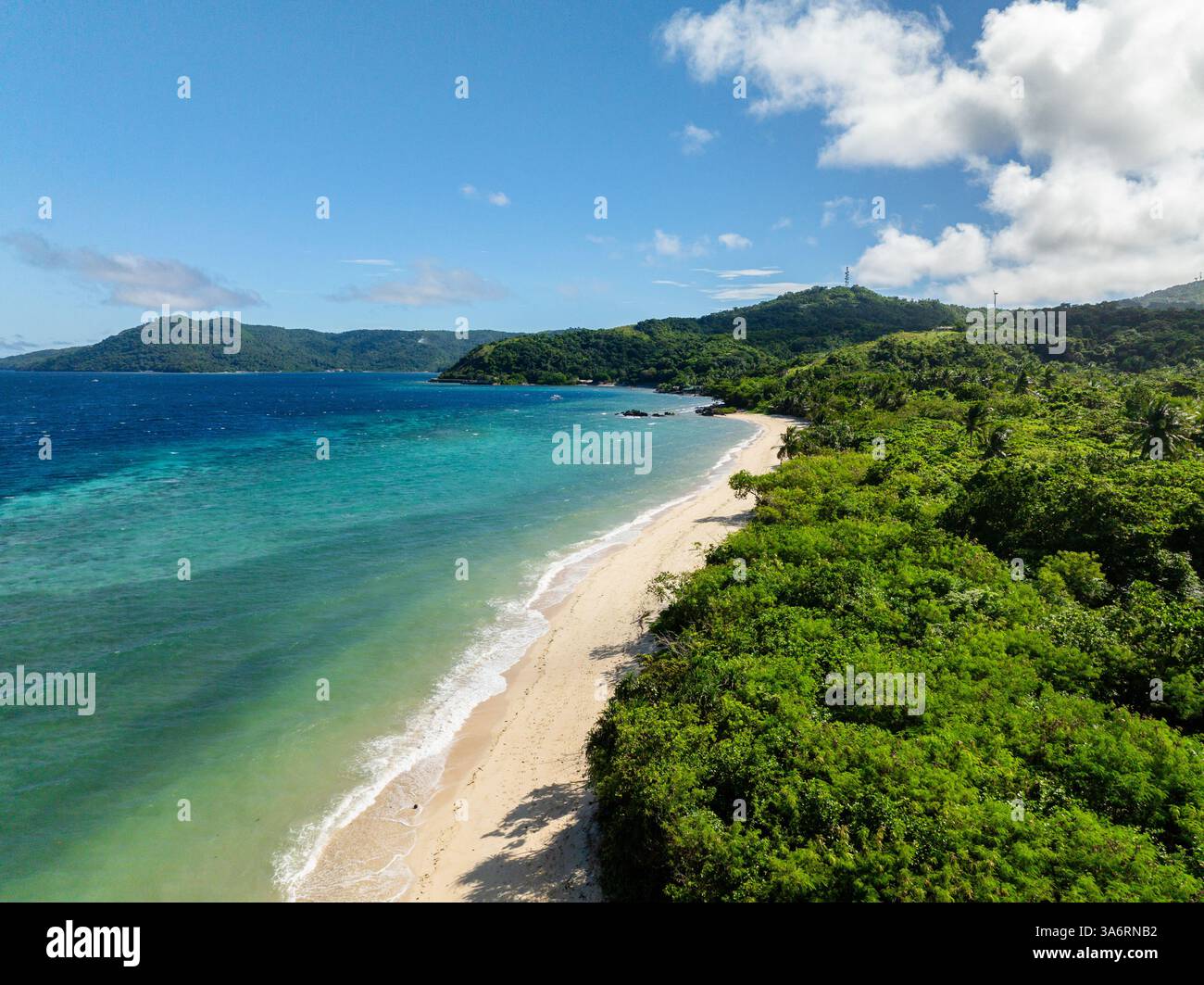 Drone view of Bon Bon Beach with turquoise sea waves on sandy beach ...