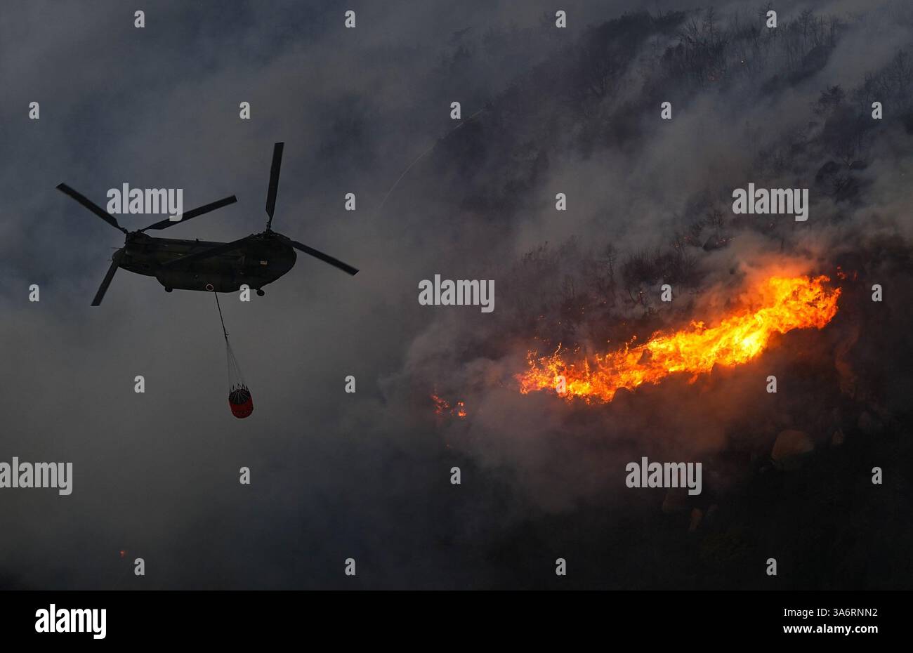 Photo taken from a Kyodo News helicopter shows firefighting operations ...