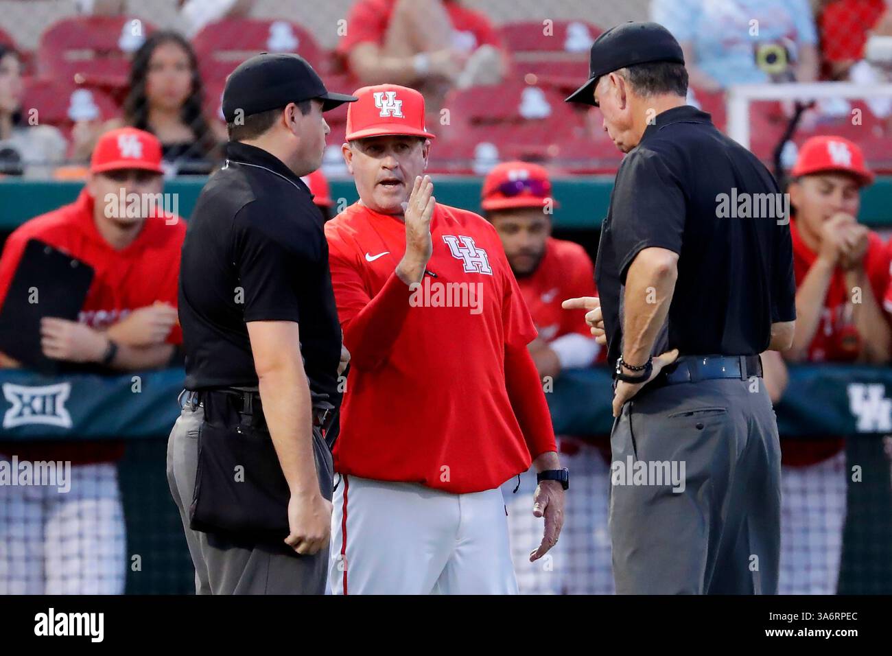 Houston head coach Todd Whitting, center, argues with umpires if a hit ...