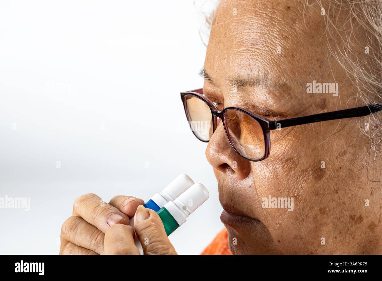 Inhaler Therapy: Anxious Senior Asian Woman Carefully Inserts Two ...