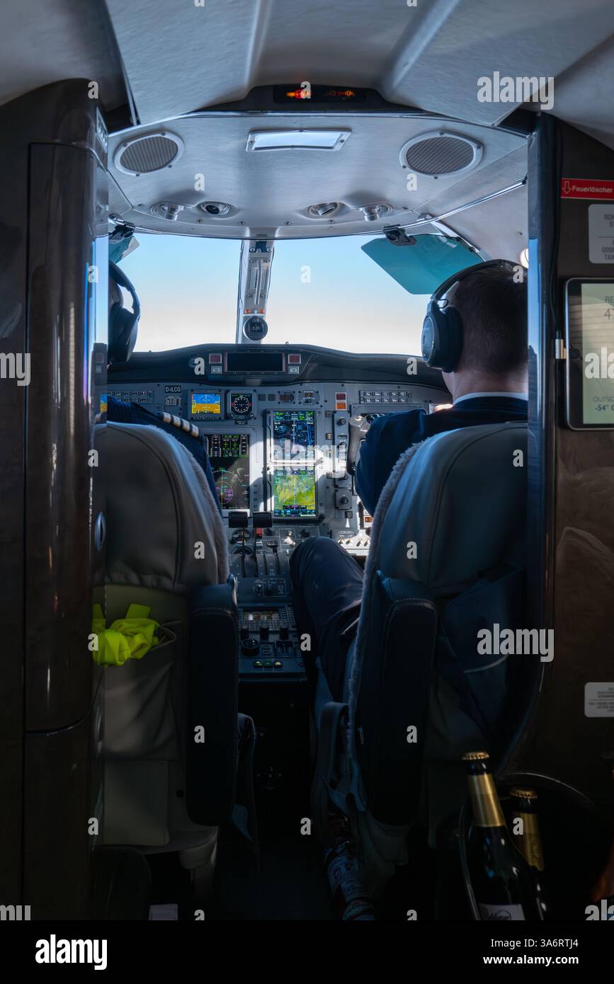 The pilots of a private jet sit in the cockpit Stock Photo - Alamy