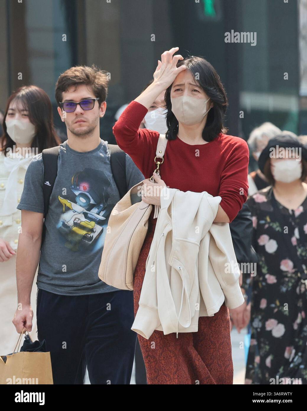 People walk on a street while the temperature rises in Ginza, Tokyo on ...