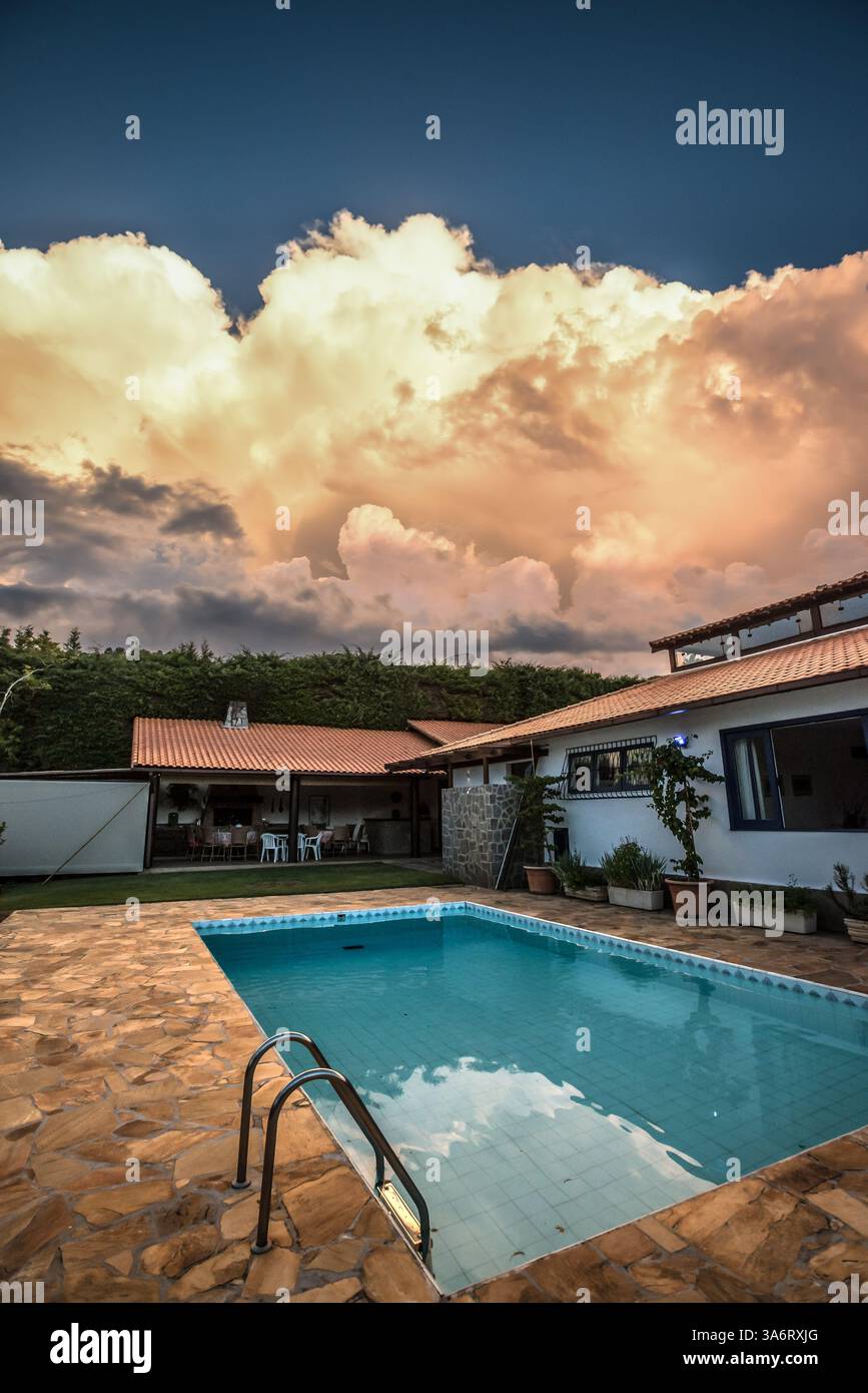 Backyard Pool with Sunset Clouds in Brazil Stock Photo - Alamy
