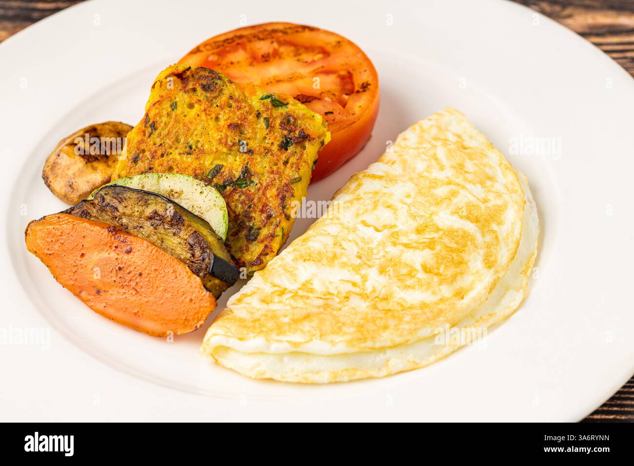 Rustic breakfast plate with fried eggs, grilled vegetables, and turkey ...