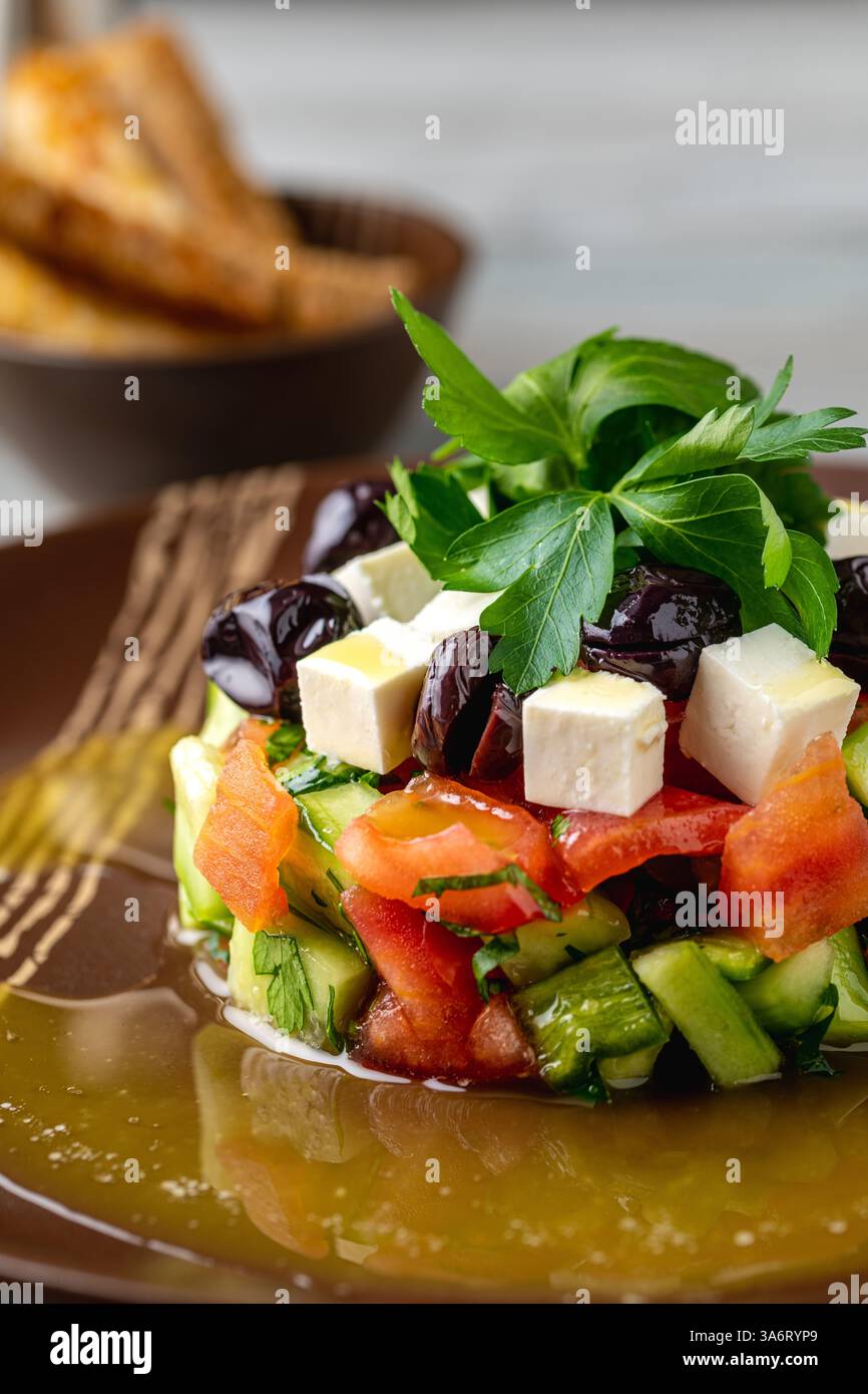 Shepherds salad served in a porcelain plate with crispy bread on the ...