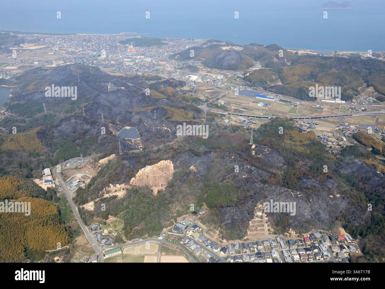 Aerial photo shows burnt mountain forest due to forest fire in Imabari ...