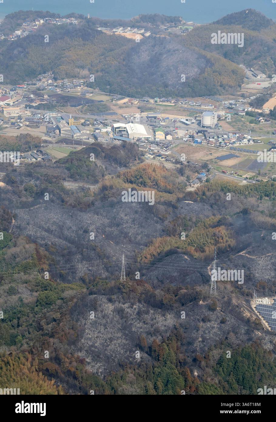 Aerial photo shows burnt mountain forest due to forest fire in Imabari ...