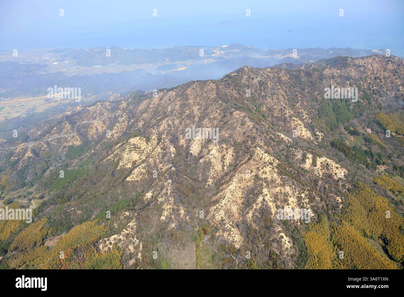 Aerial photo shows burnt mountain forest due to forest fire in Imabari ...