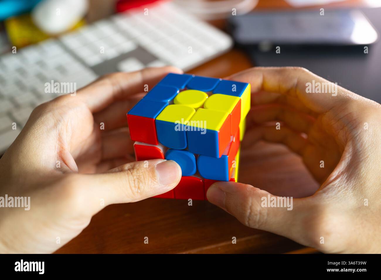 Bangkok, Thailand - March 22, 2025 : A man solving a Rubik's cube Stock Photo - Alamy