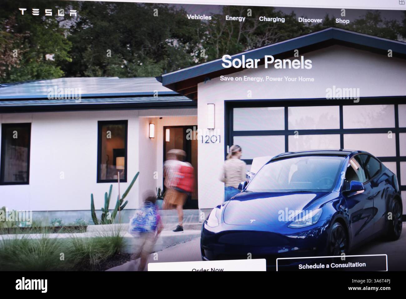 Modern home with solar panels displayed on tesla website with family ...