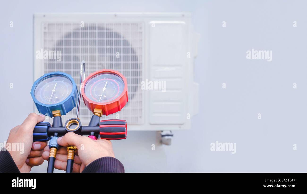 Air repair mechanic using measuring equipment for filling industrial ...