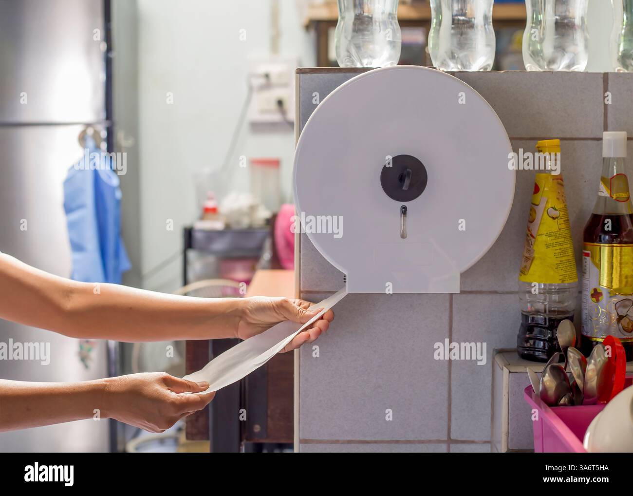 The maid was pulling the tissue paper by hand for cleaning Stock Photo ...