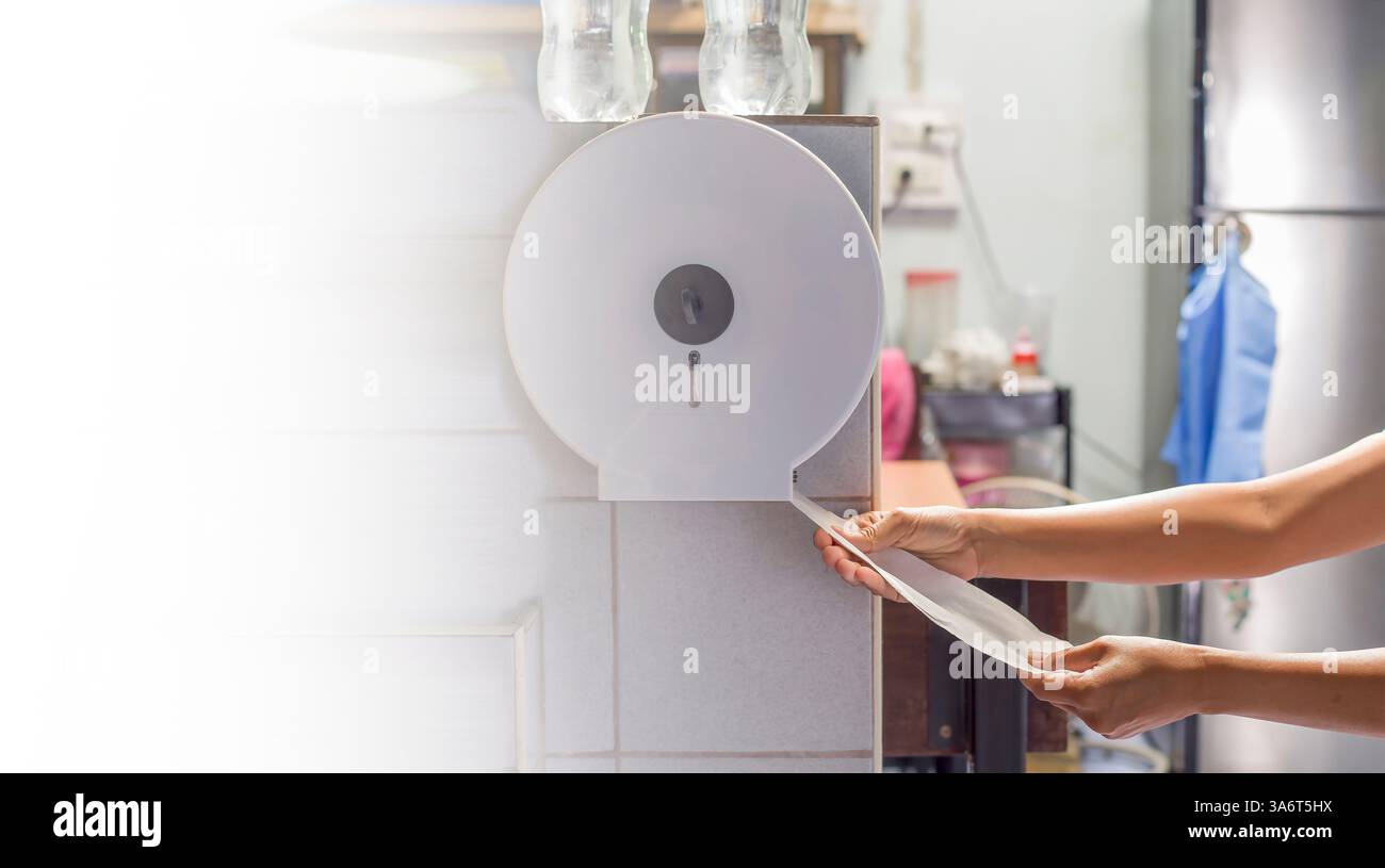 The maid was pulling the tissue paper by hand for cleaning Stock Photo ...