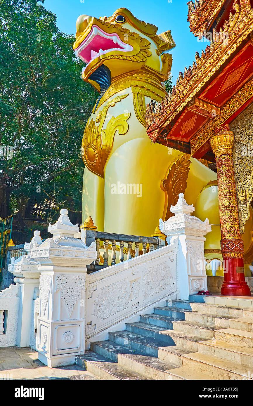 The entrance to the covered gallery of Shwedagon Pagoda with giant ...