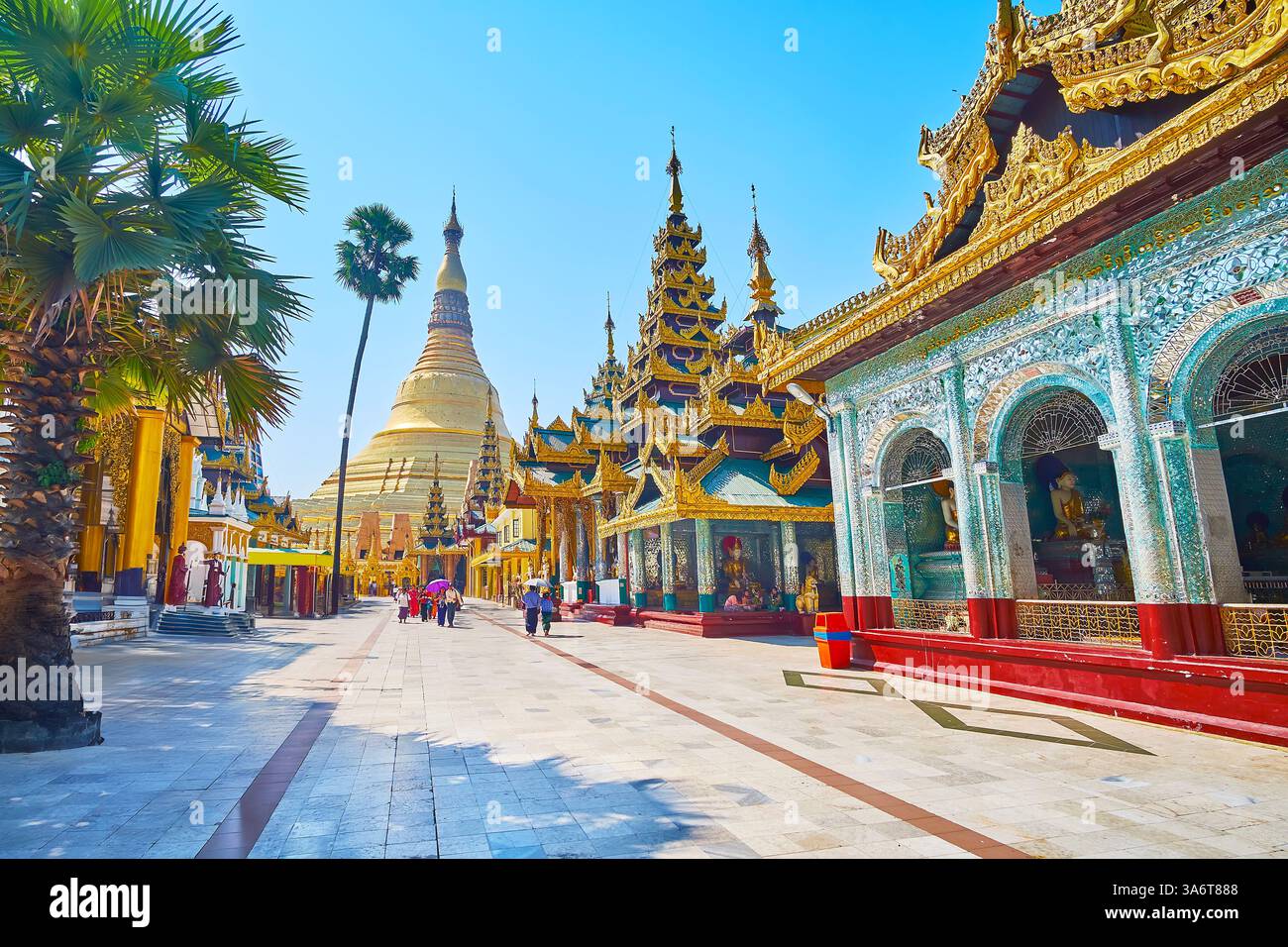 The way from the North entrance to the great golden Stupa of Shwedagon with numerous scenic ...