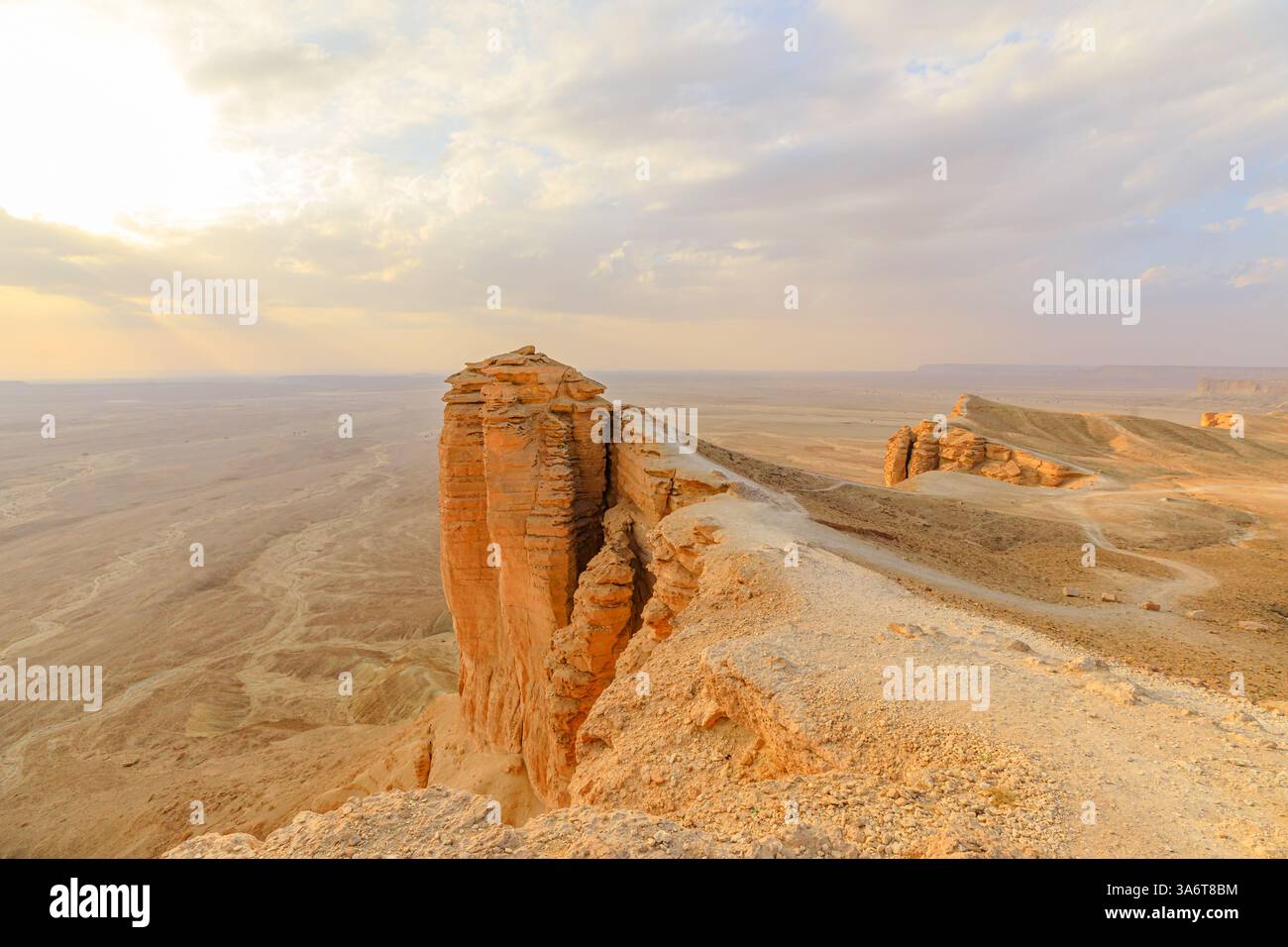 Golden hour sunlight illuminates the Tuwaiq escarpment at sunset ...