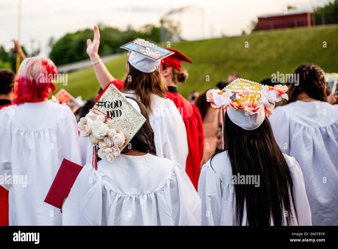 High school graduates march out of commencement celebrating in their ...