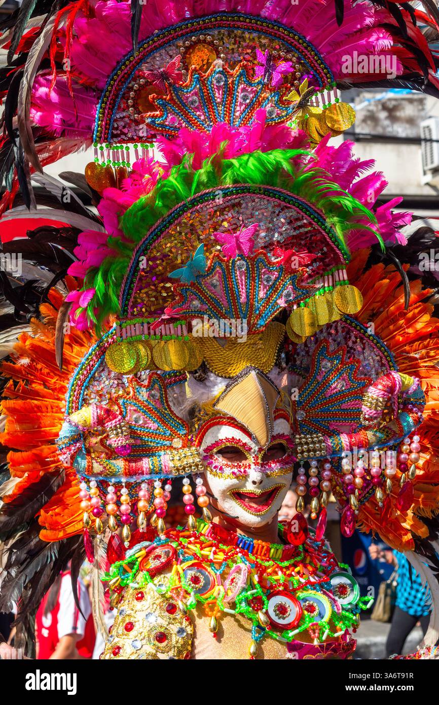 Colorful and elaborately costumed Masskara Festival dancers wearing ...