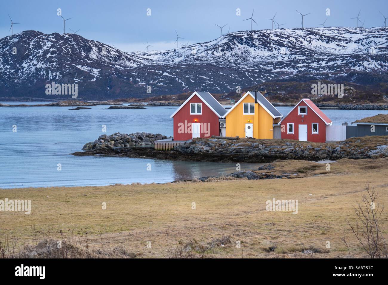 three beautiful, colorful houses on shore of North Atlantic. wooden ...