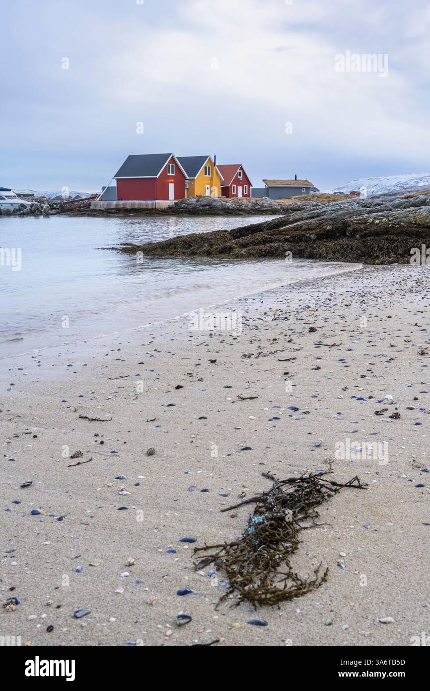 three beautiful, colorful houses on shore of North Atlantic. wooden ...
