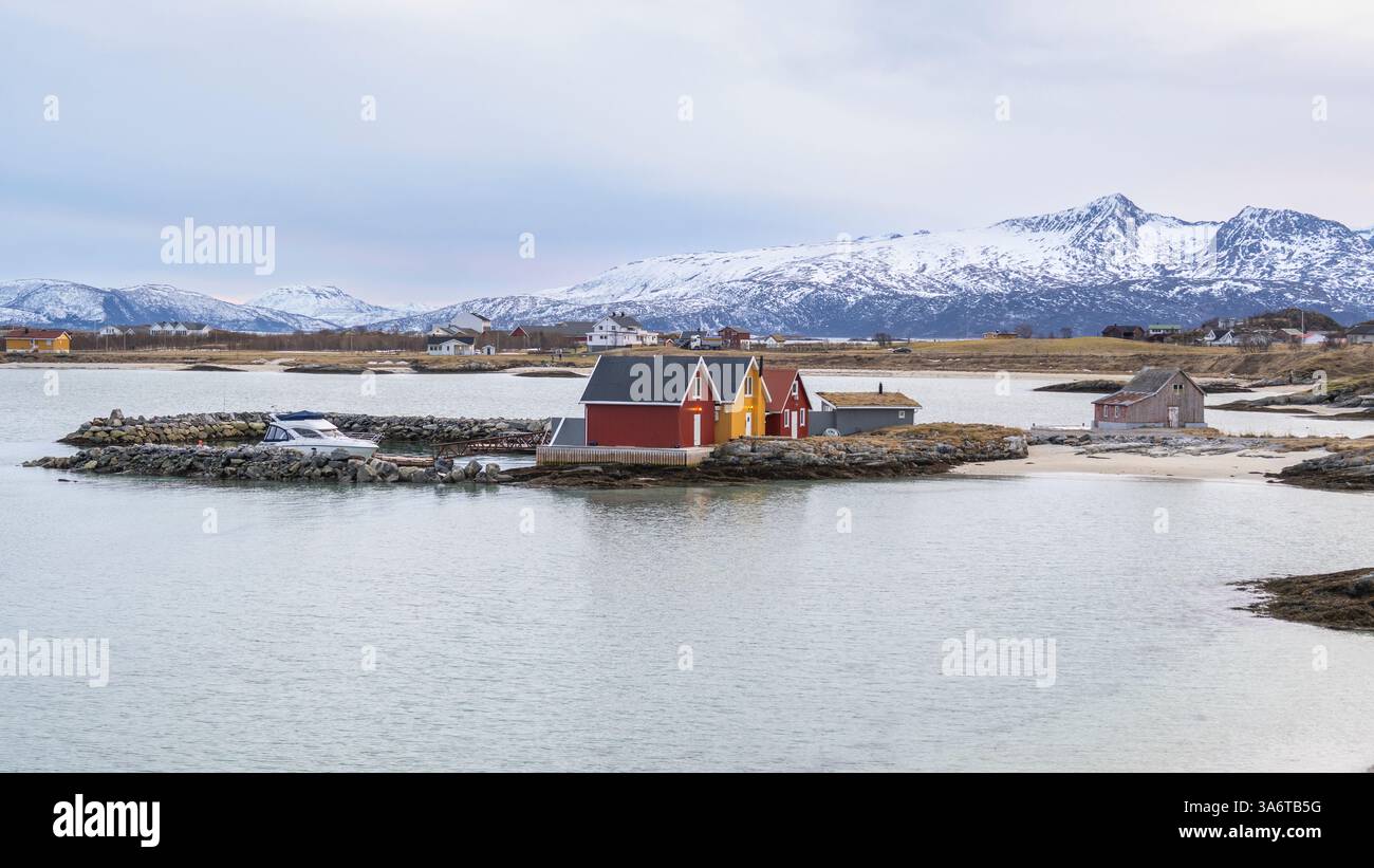 three beautiful, colorful houses on shore of North Atlantic. wooden ...