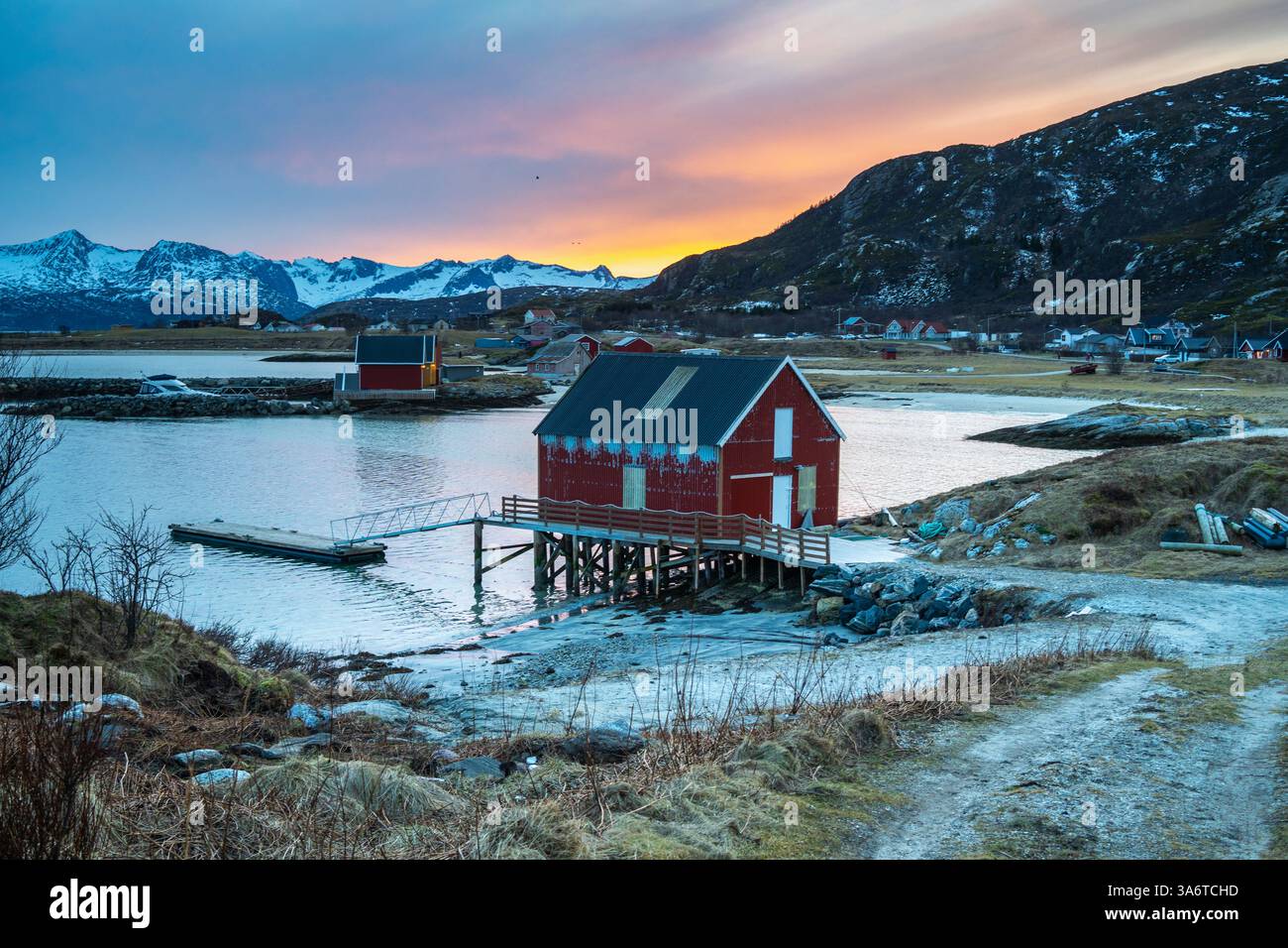 three beautiful, colorful houses on shore of North Atlantic. wooden ...