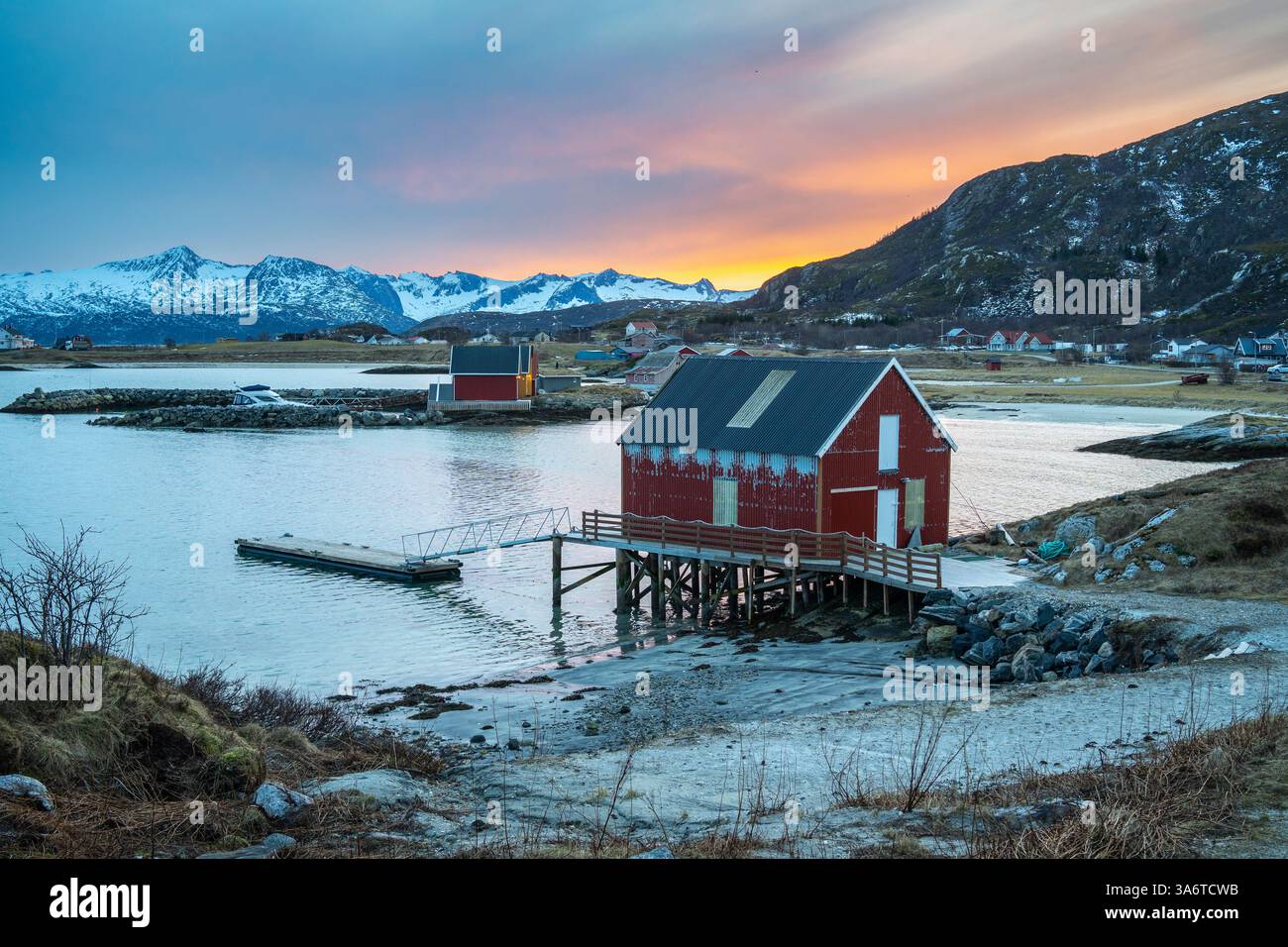 three beautiful, colorful houses on shore of North Atlantic. wooden ...