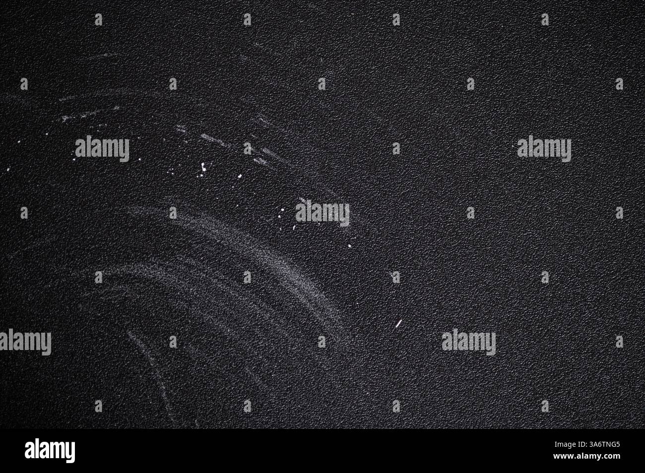 Powdery substance chalk board sweeping across dark textured surface ...