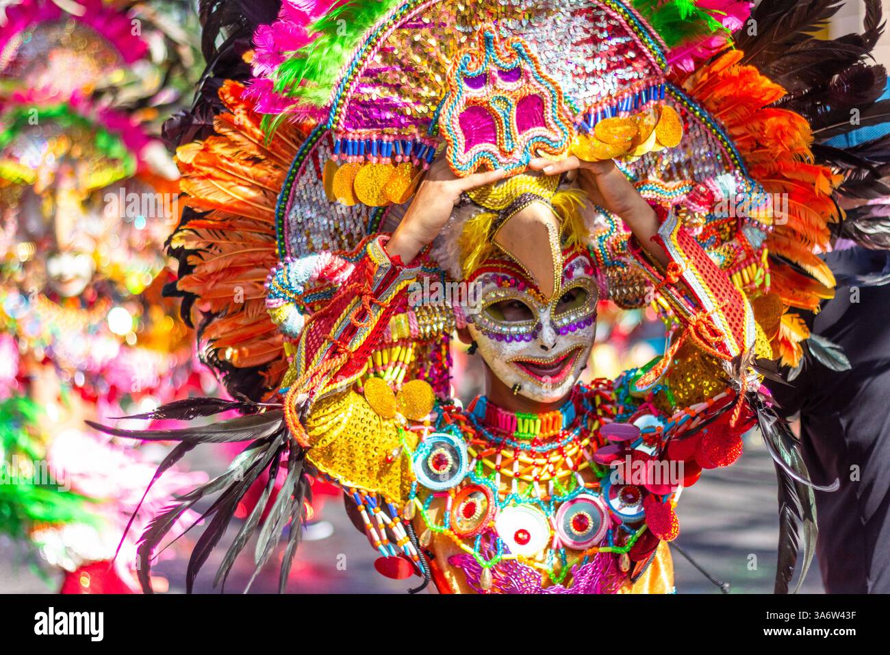 Colorful and elaborately costumed Masskara Festival dancers wearing ...