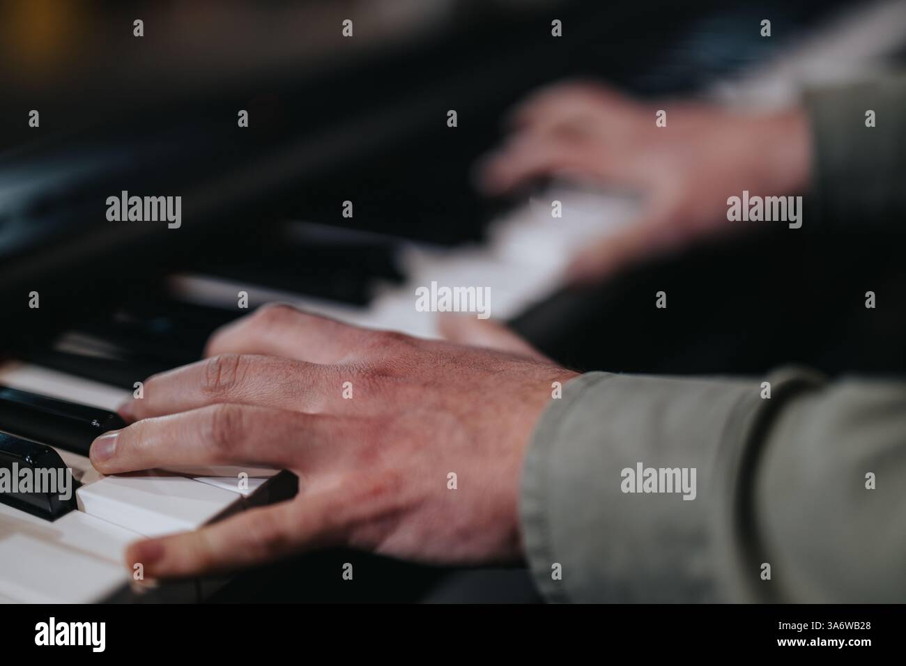 Hands playing piano keys during an intimate music performance Stock ...