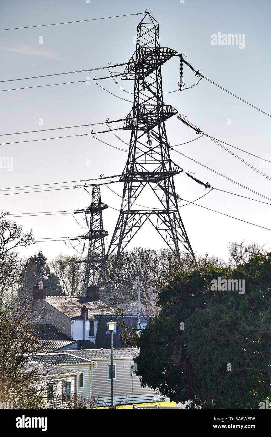 Electricity power lines and pylons in close proximity to houses and ...