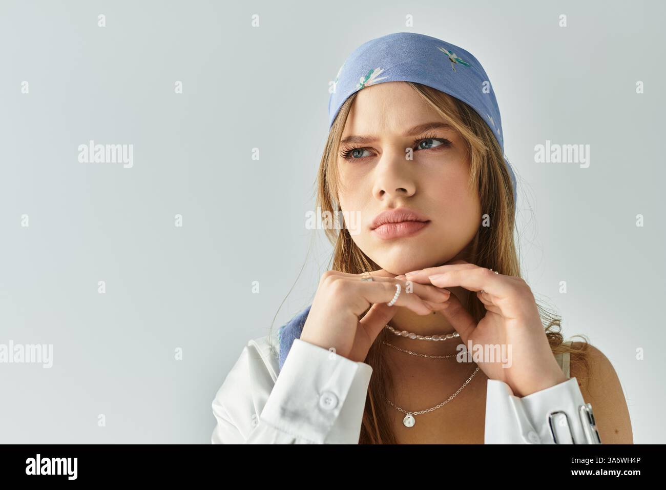 A stylish young woman poses in spring attire, evoking a fresh and ...