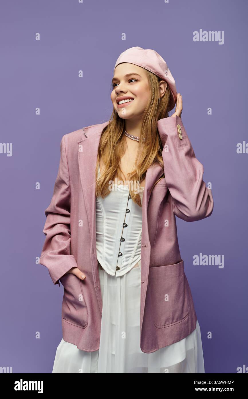 A young woman models a stylish spring outfit against a bright purple ...
